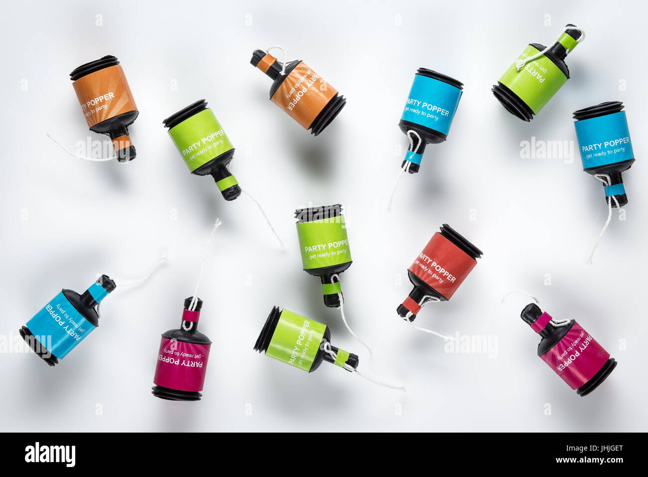 Multicolour Party Poppers from above on white background Stock Photo ...