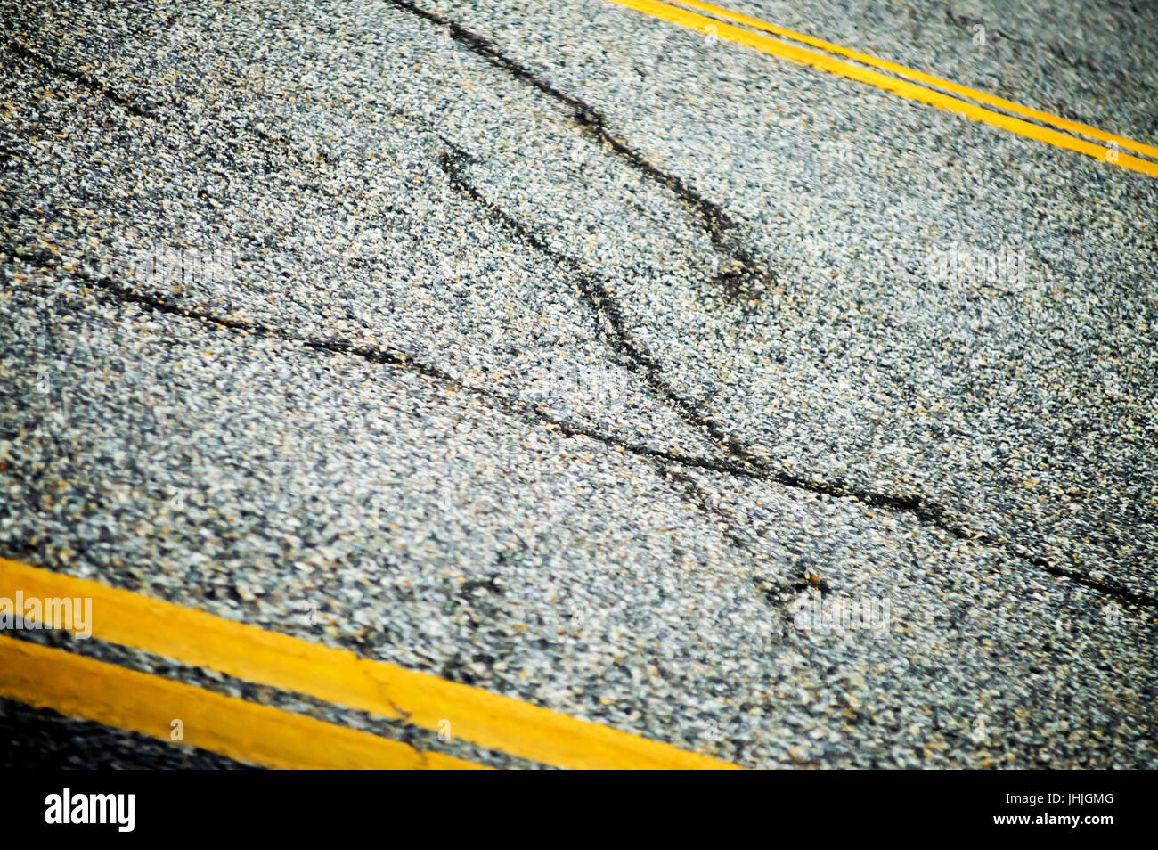 A section of cracked pavement with traffic lines Stock Photo - Alamy
