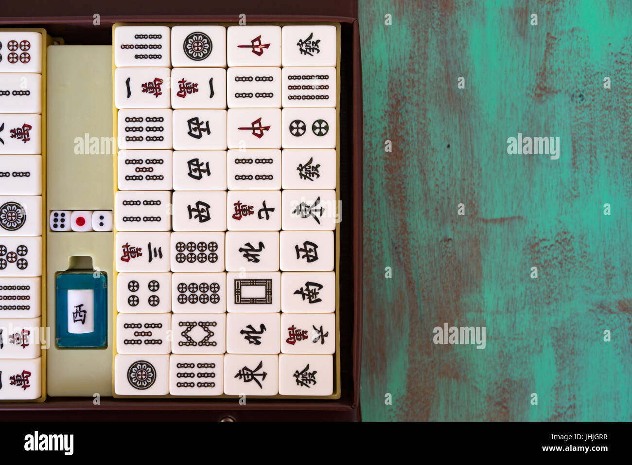 Mahjong '麻將' tiles set and box on green wooden background, flat lay ...