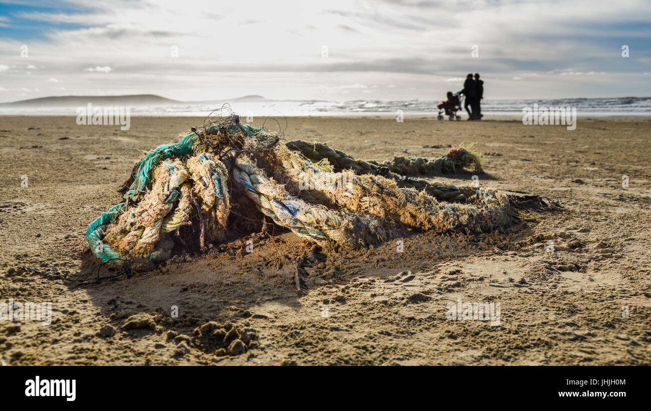 Knot of tangled rope and netting on beach after high tide. Wales. UK ...