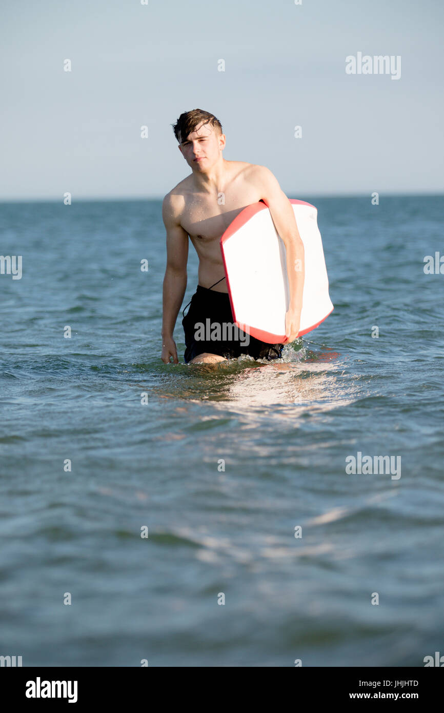 Young boy with bodyboard hi-res stock photography and images - Alamy