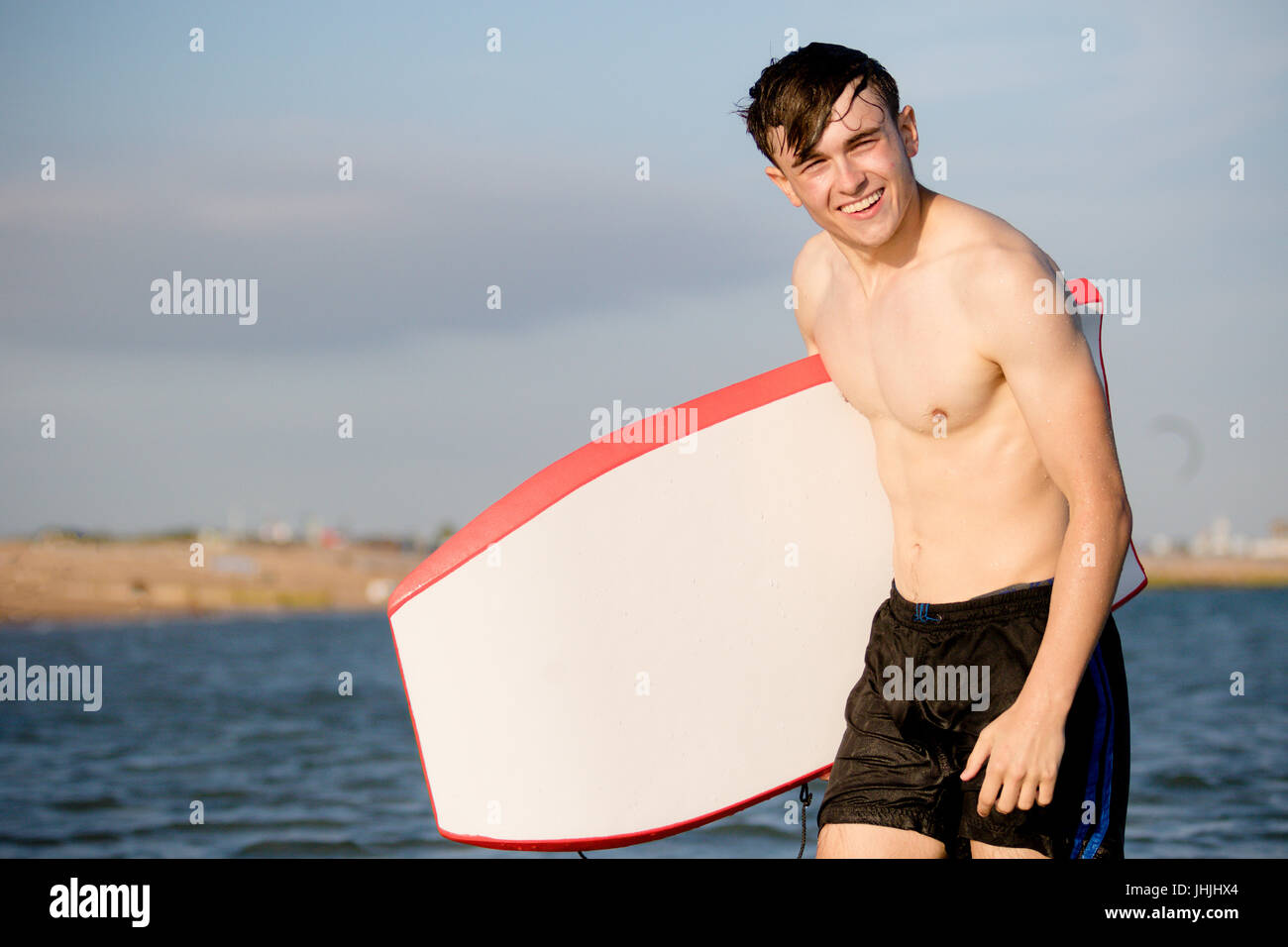 Young boy with bodyboard hi-res stock photography and images - Alamy