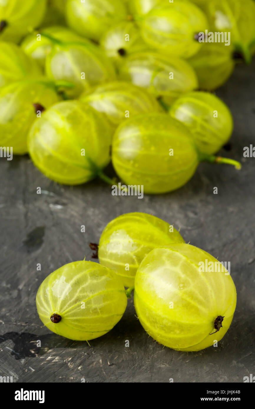 Heap of ripe, fresh harvested green gooseberry fruit on dark background ...