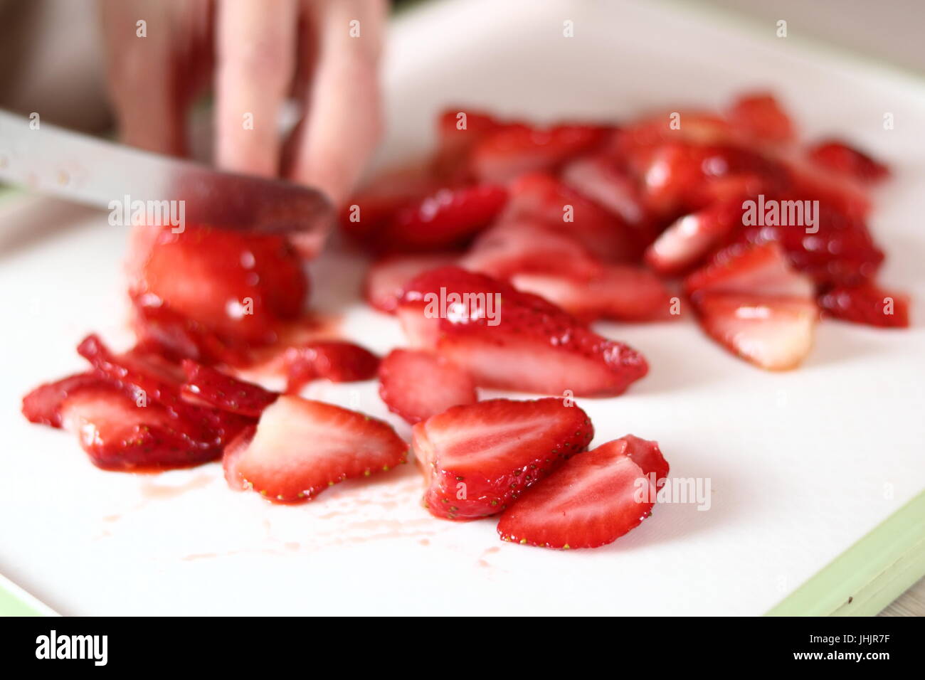 Slicing strawberry. Making frozen strawberry cheesecake series Stock ...