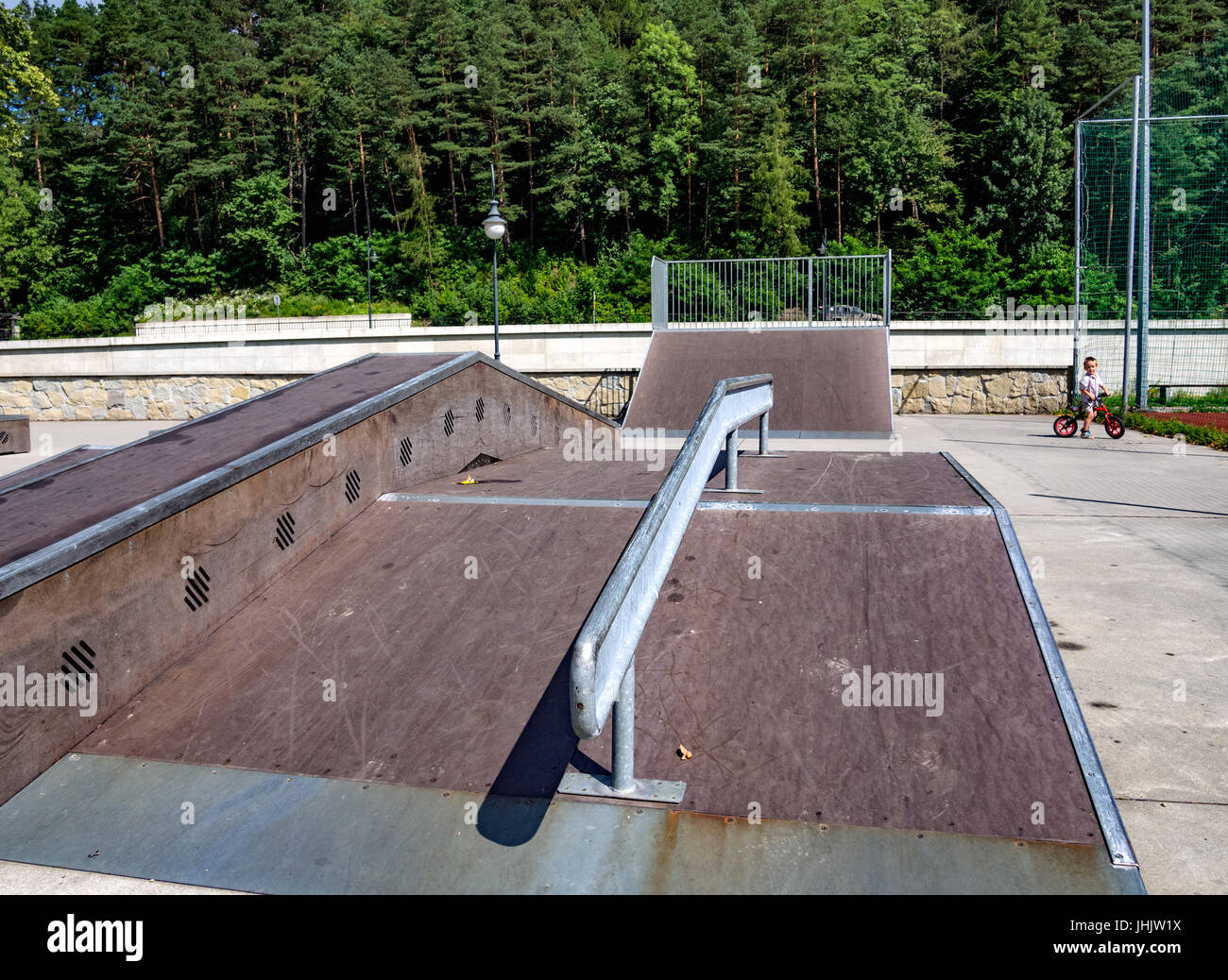 Boy riding balance bike in skate park Stock Photo - Alamy
