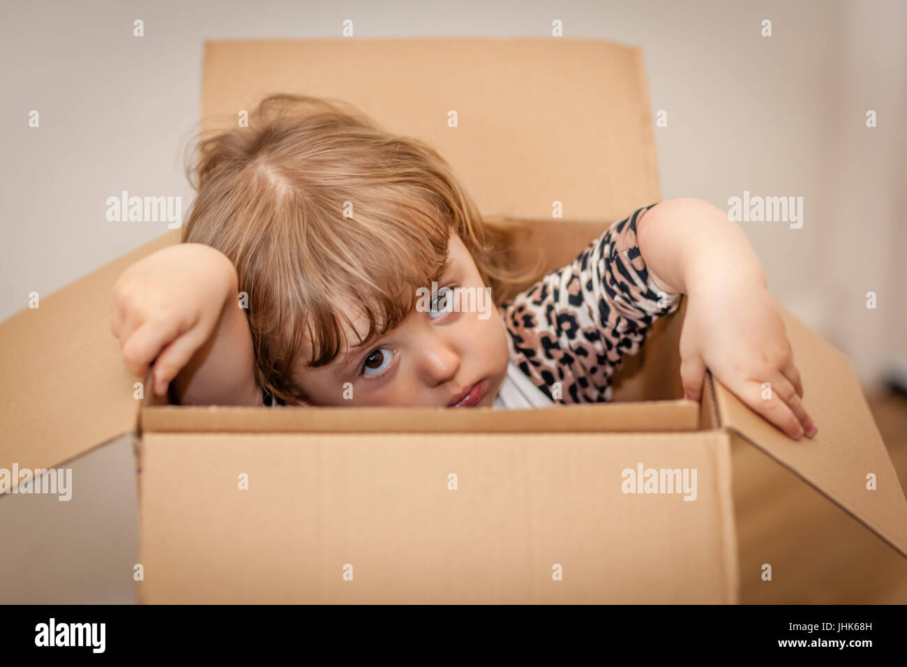 Girl popping out of a cardboard box Stock Photo - Alamy