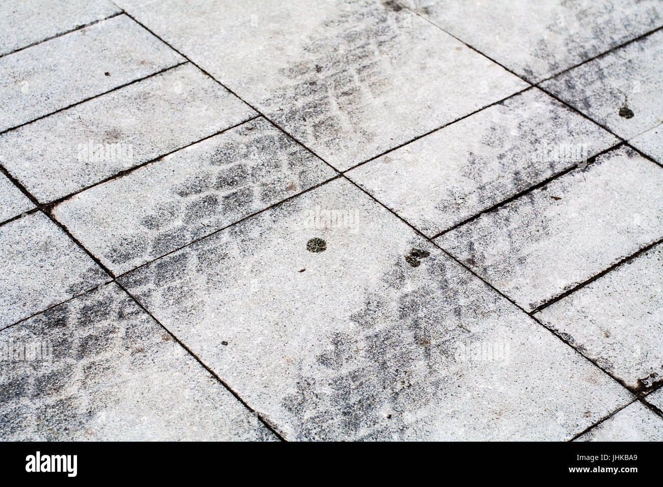 tire traces on gray tile. background Stock Photo - Alamy
