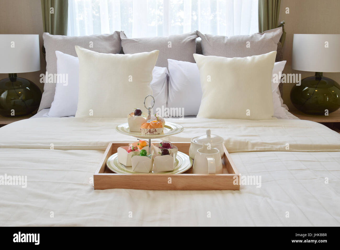 bedroom interior design with decorative tea set and dessert on bed ...