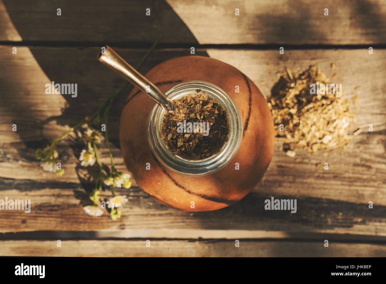 High angle view of Argentinean yerba mate drink on a wooden background ...