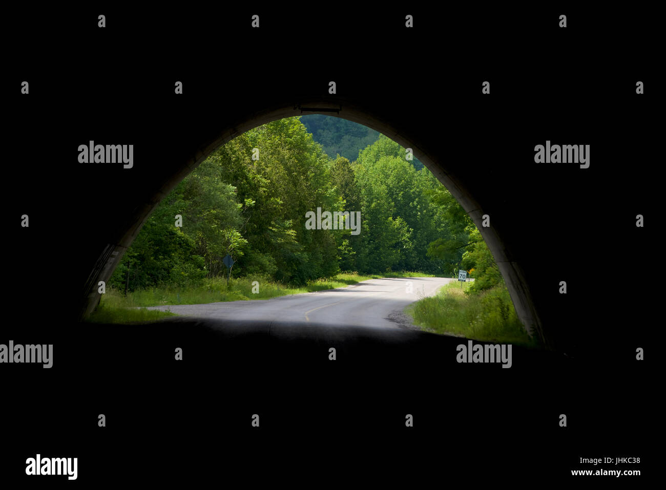 View out from a road tunnel into countryside Stock Photo - Alamy