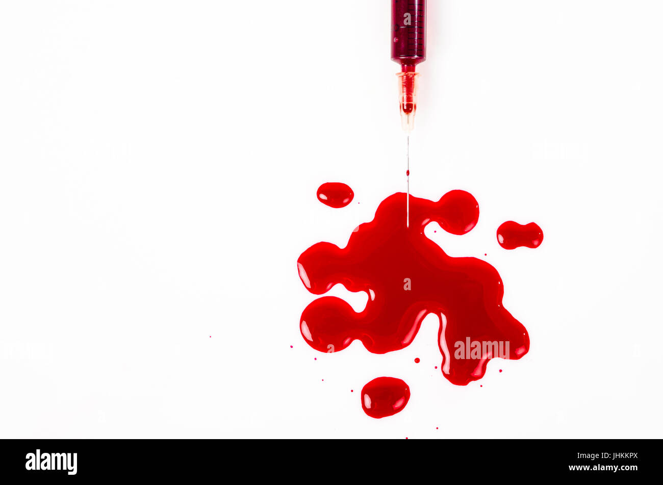 Drop of blood from needle syringe over white background Stock Photo - Alamy