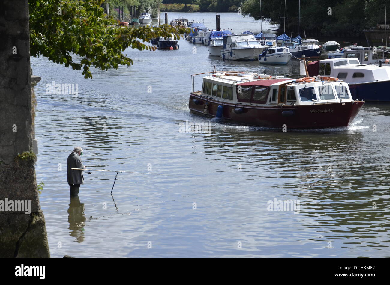 A man fishing in the River Thames between Twickenham and Eel Pie Island ...