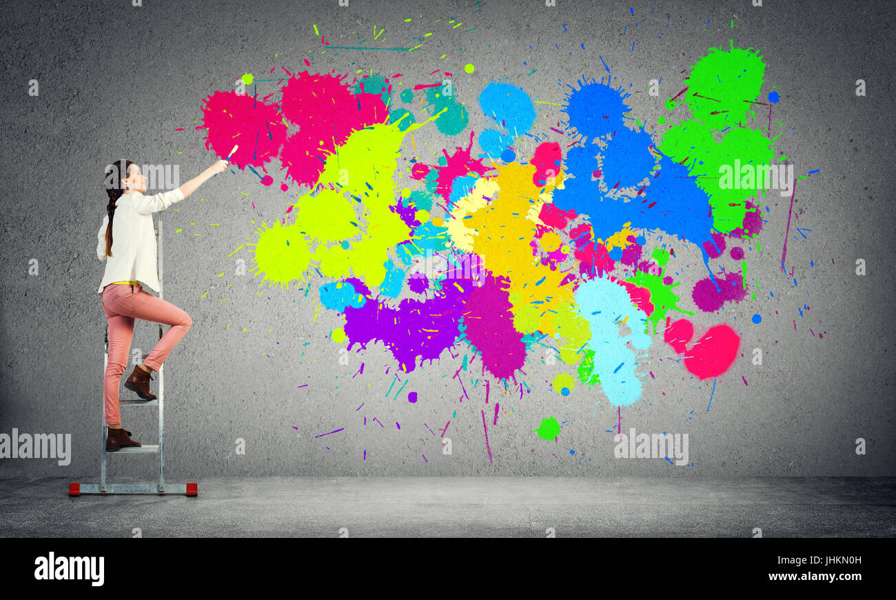 Girl paint wall in colors Stock Photo - Alamy