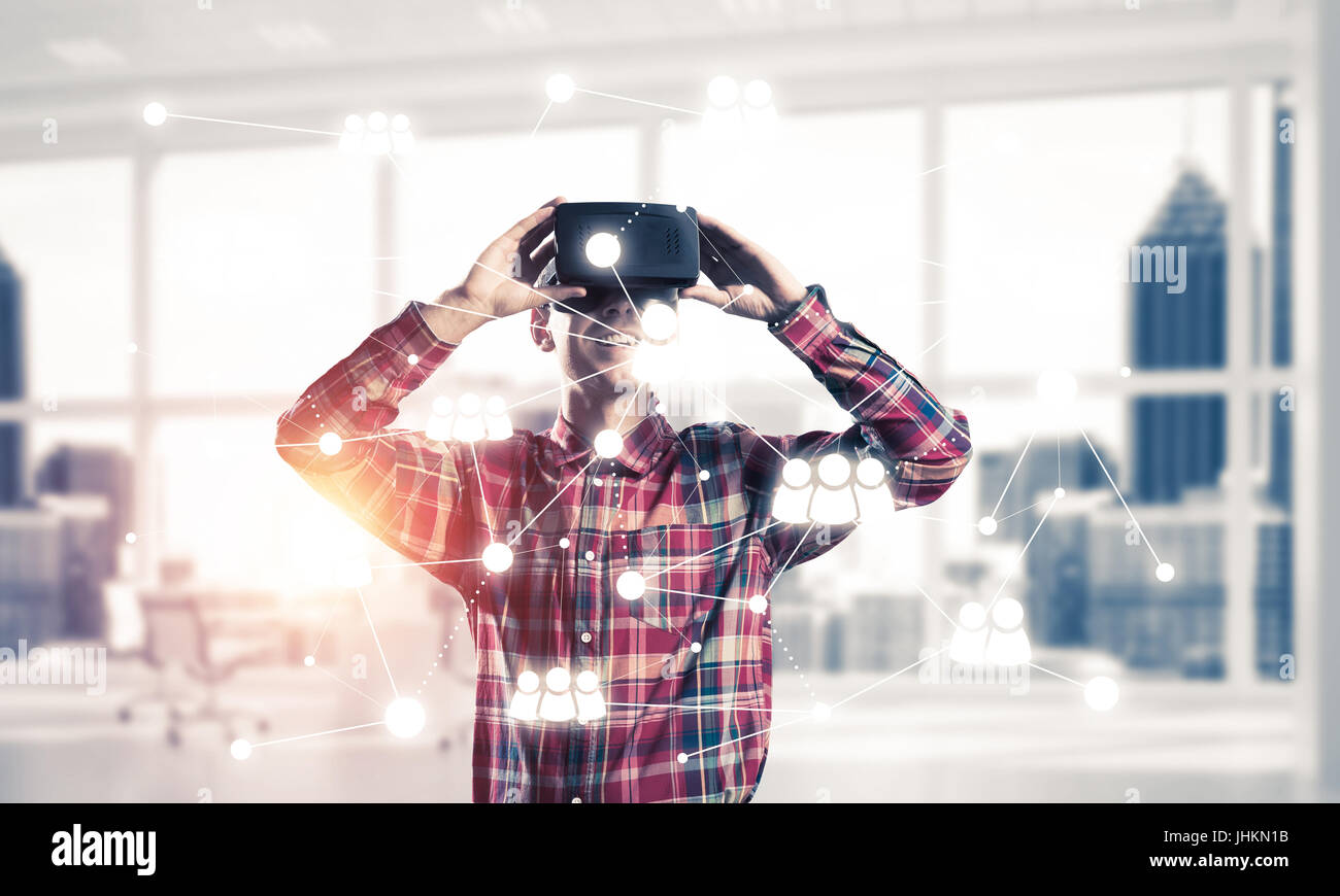 Guy wearing checked shirt and virtual mask demonstrating some em Stock ...