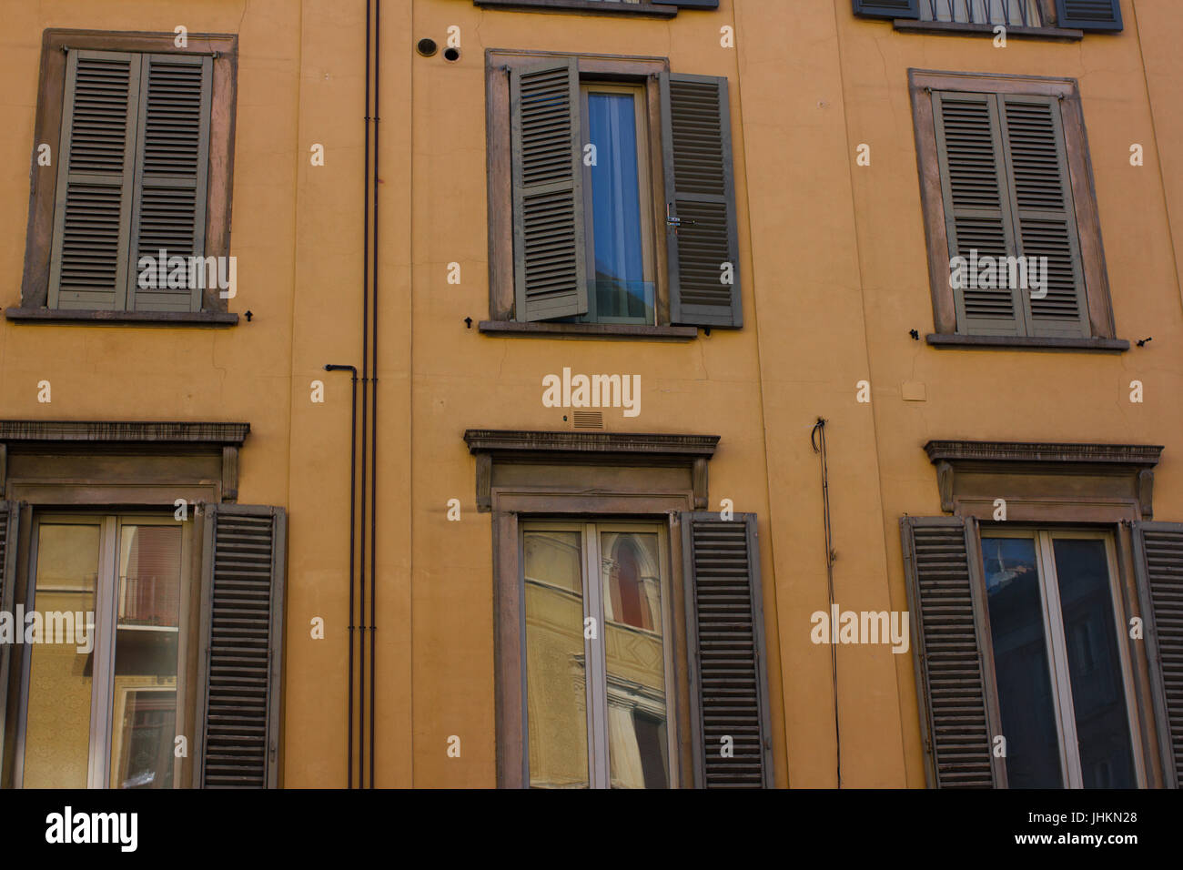 Many windows. Medieval facade. Window shutters. Architectural style of ...