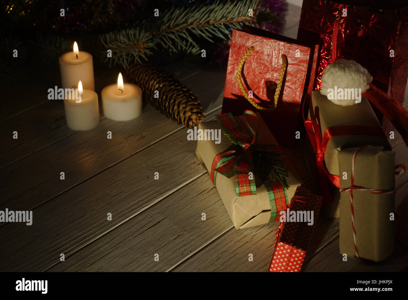 Side view of the Christmas presents placed on the table decorated with ...