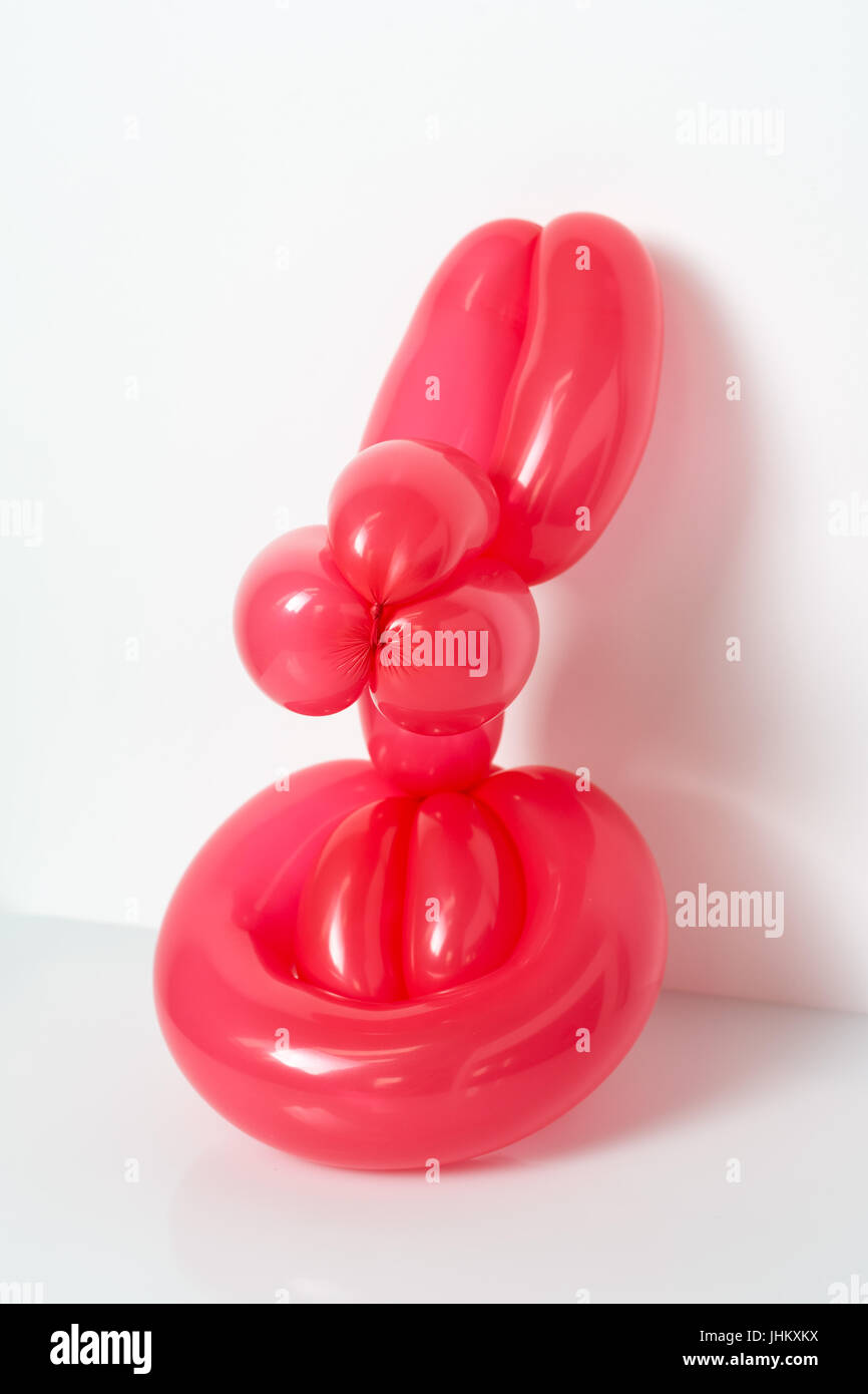 Simple red twisted balloon animal rabbit on white. Toy of balloons ...