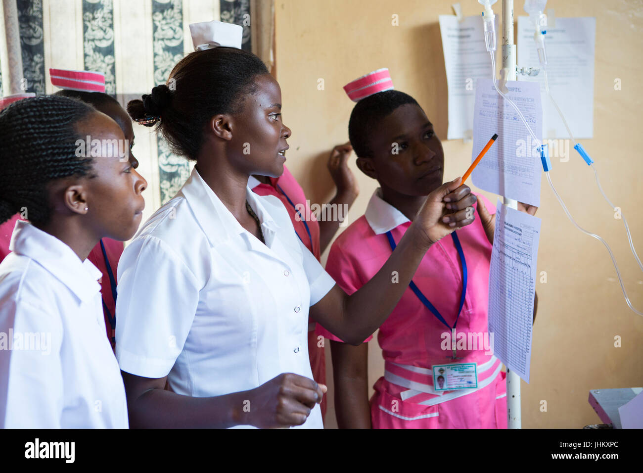 A nurse, making notes of the patients scores and observations during a ...