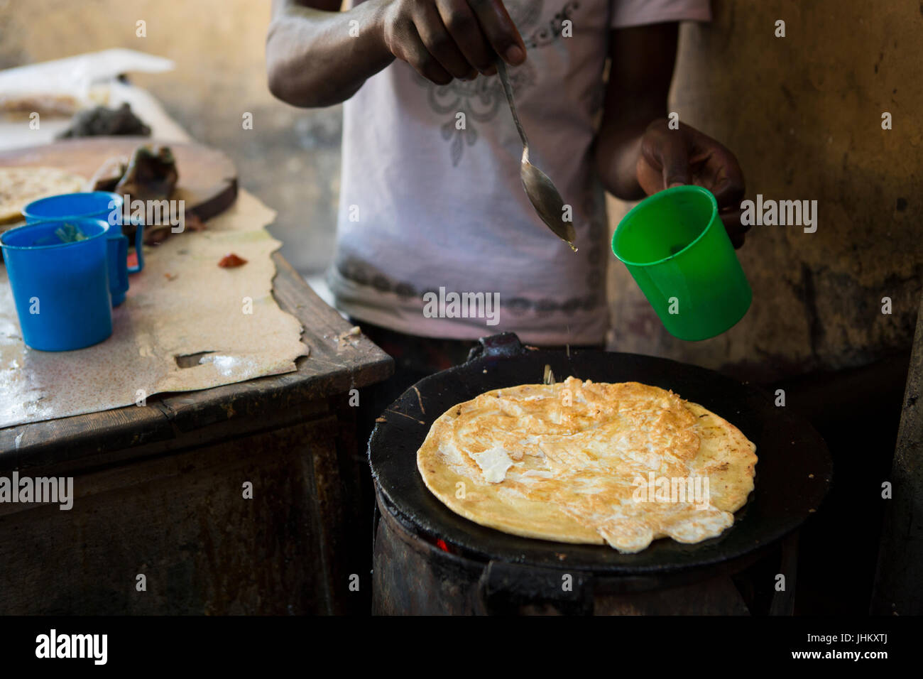 A Uganda Rolex being made by the side of the road. A rolex is a ...