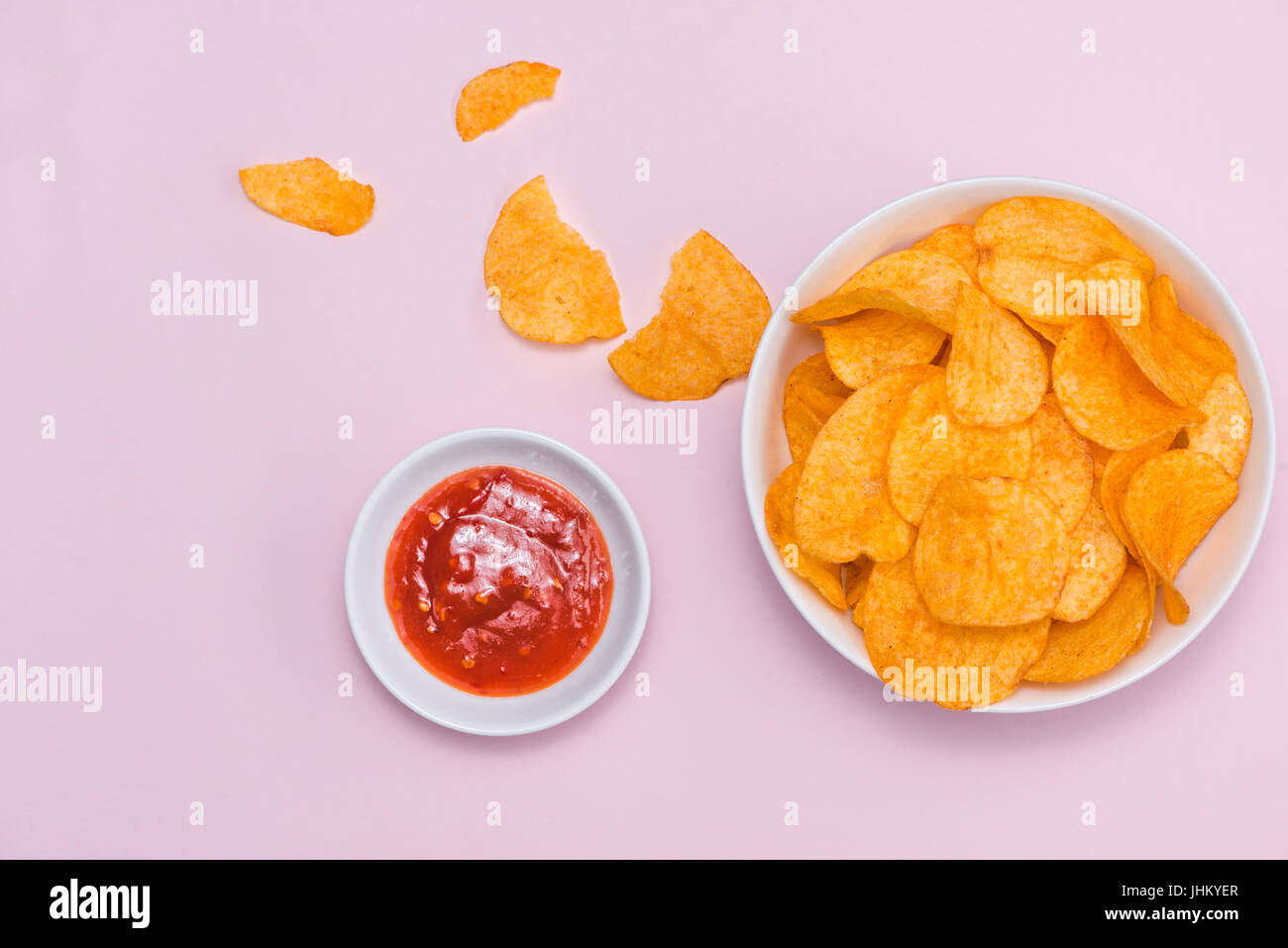 Concept of unhealthy food. Chips in a bowl and ketchup Stock Photo - Alamy