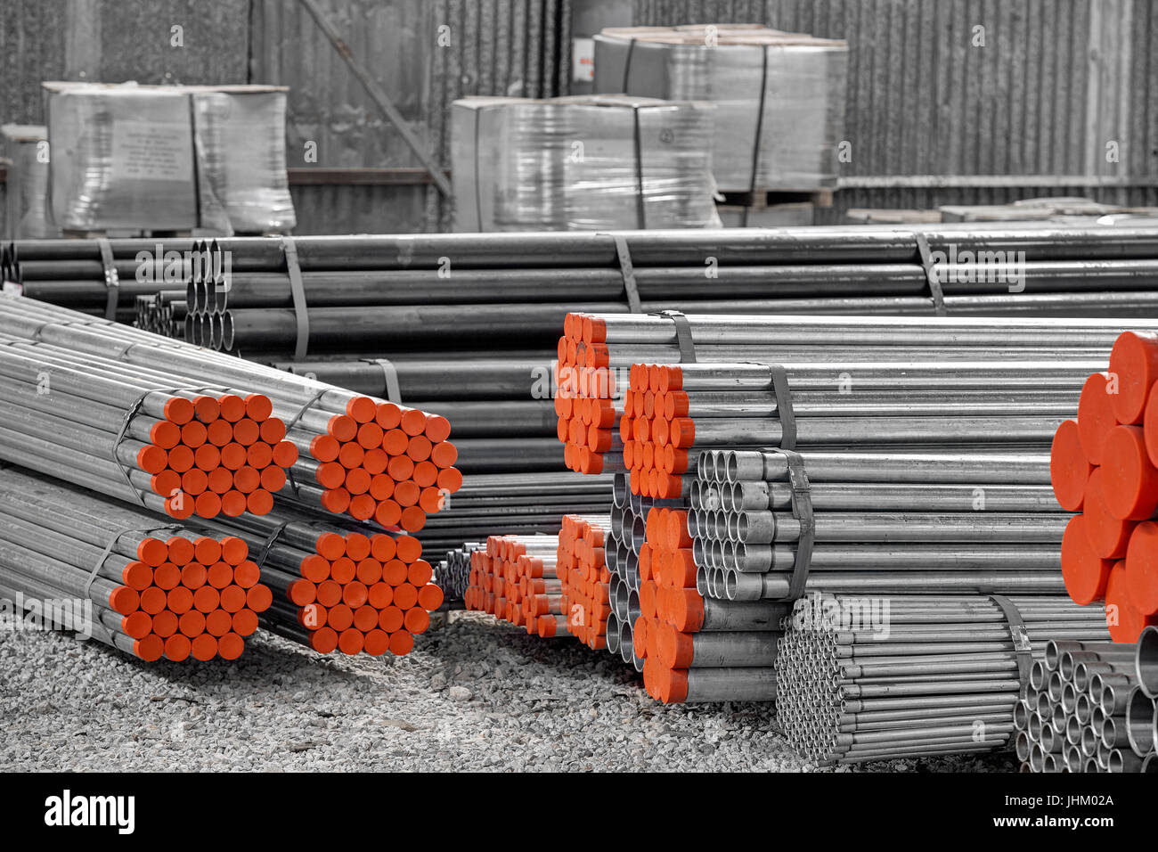Steel Pipes bunch on the rack in warehouse Stock Photo - Alamy
