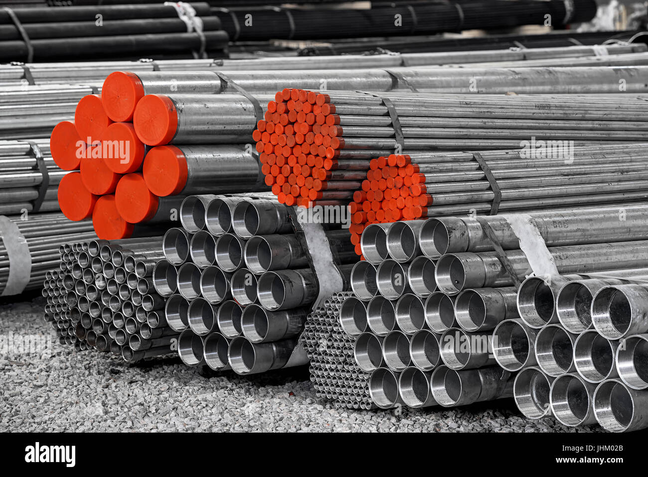 Steel Pipes bunch on the rack in warehouse Stock Photo - Alamy
