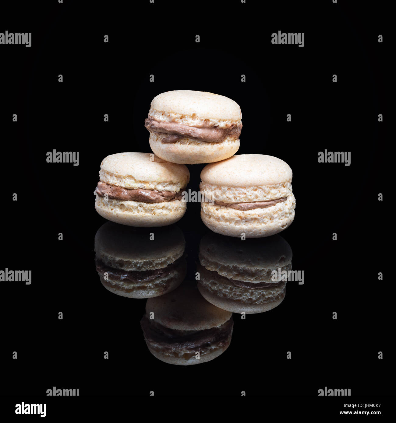 Macaroons stacked isolated on black background with reflection ...