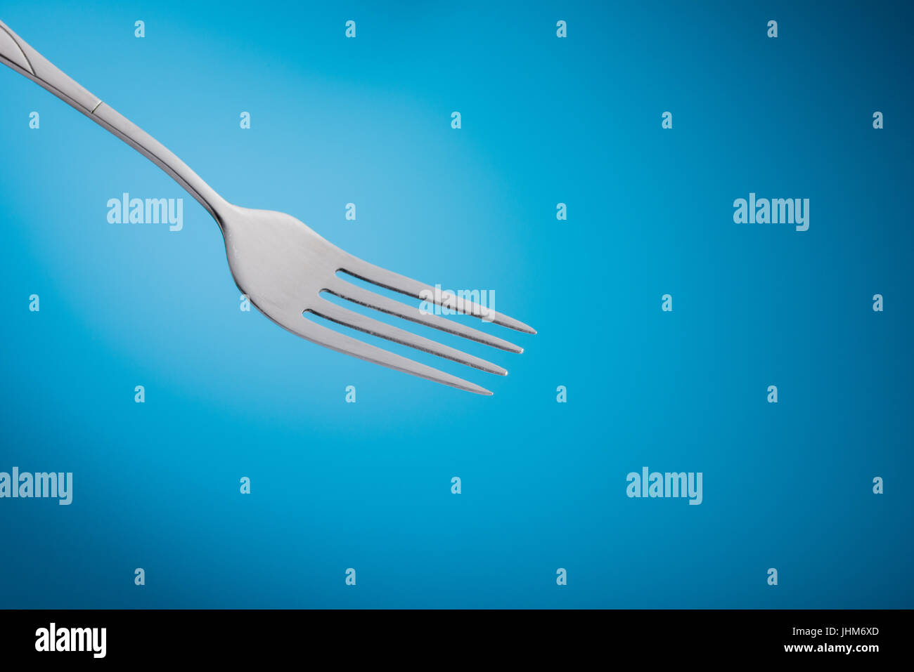 Fork in Blue Background Stock Photo - Alamy