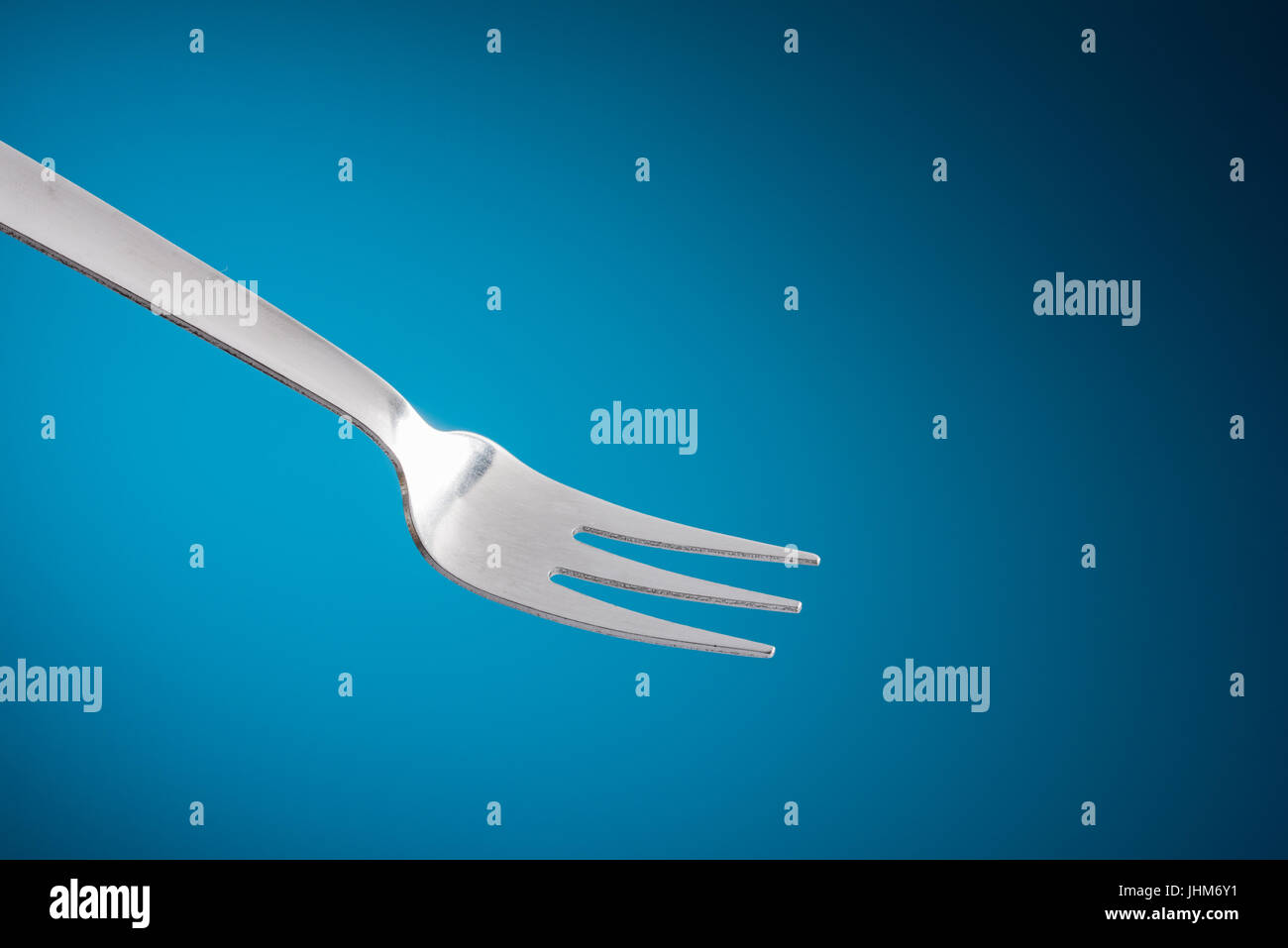 Fork in Blue Background Stock Photo - Alamy
