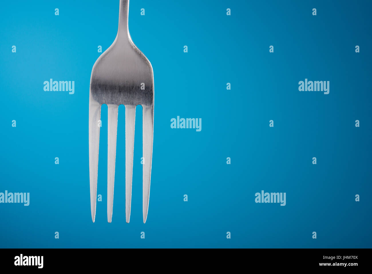Fork in Blue Background Stock Photo - Alamy