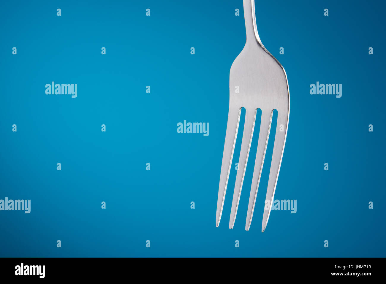 Fork in Blue Background Stock Photo - Alamy