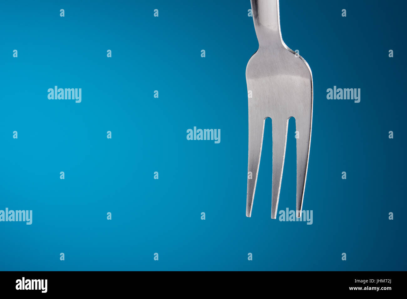 Fork in Blue Background Stock Photo - Alamy