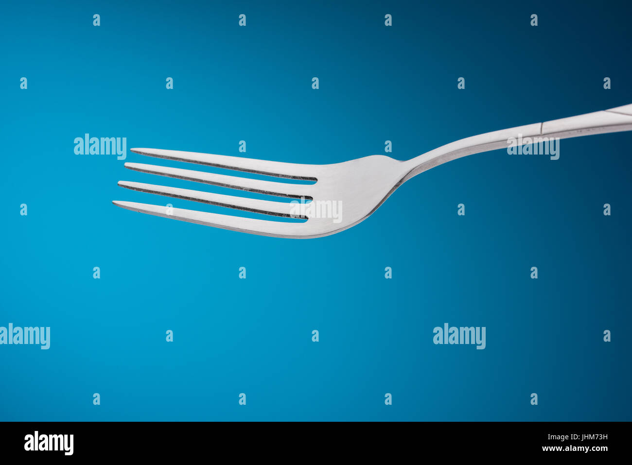 Fork in Blue Background Stock Photo - Alamy