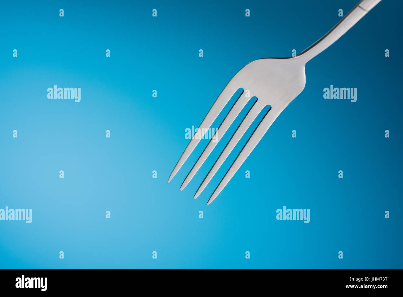 Fork in Blue Background Stock Photo - Alamy