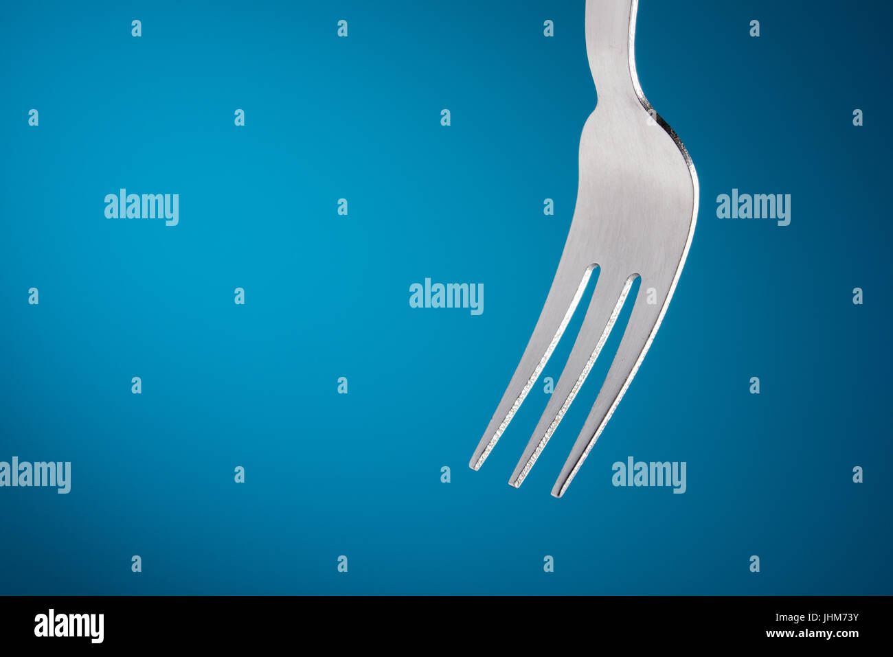Fork in Blue Background Stock Photo - Alamy