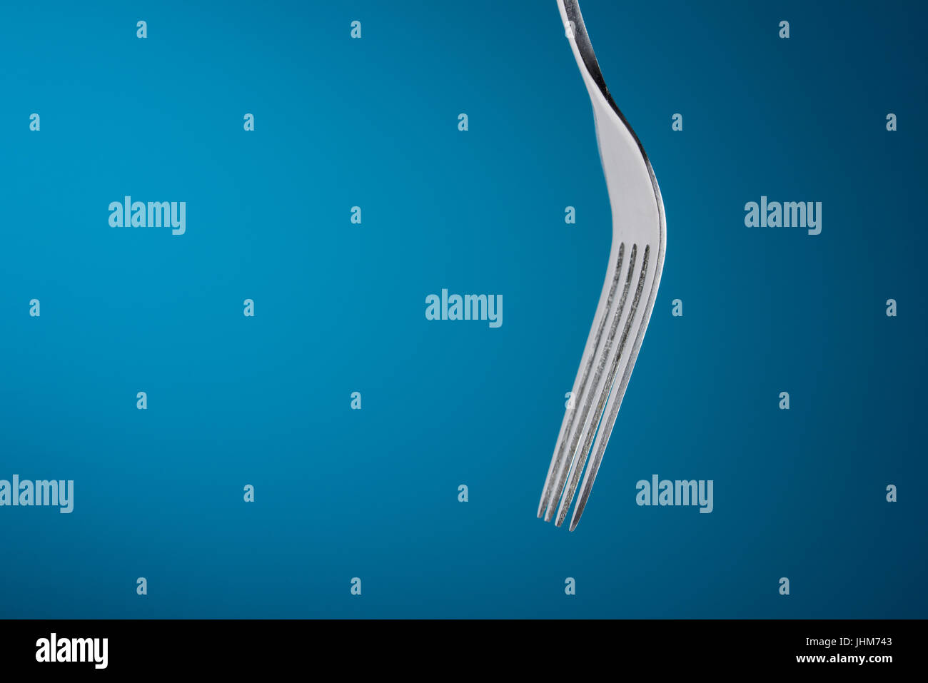 Fork in Blue Background Stock Photo - Alamy
