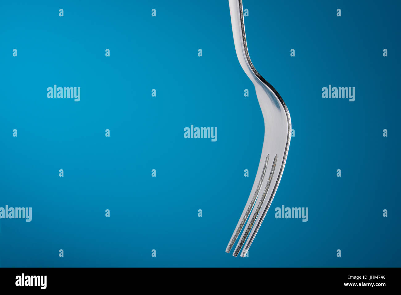 Fork in Blue Background Stock Photo - Alamy