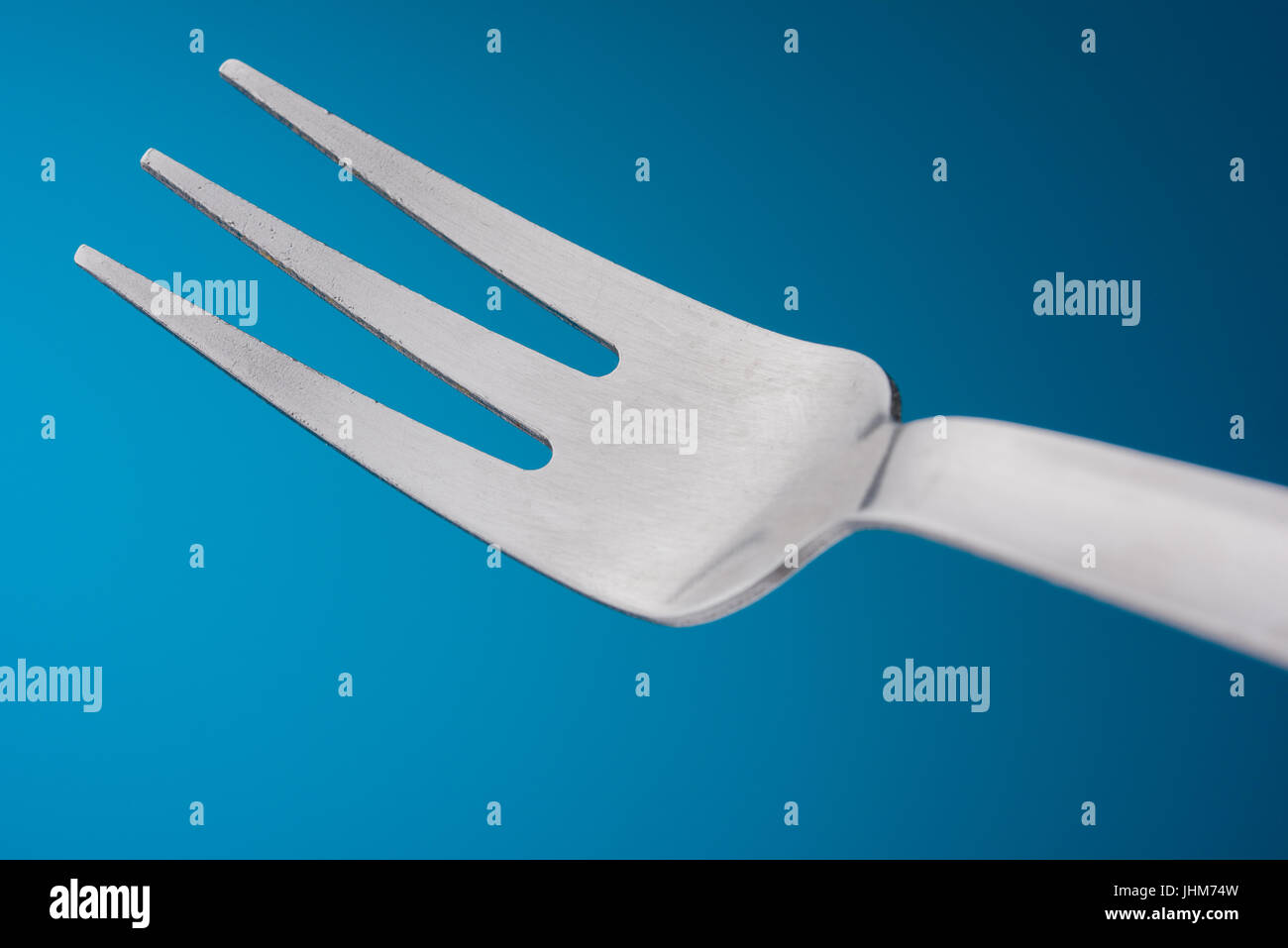 Fork in Blue Background Stock Photo - Alamy