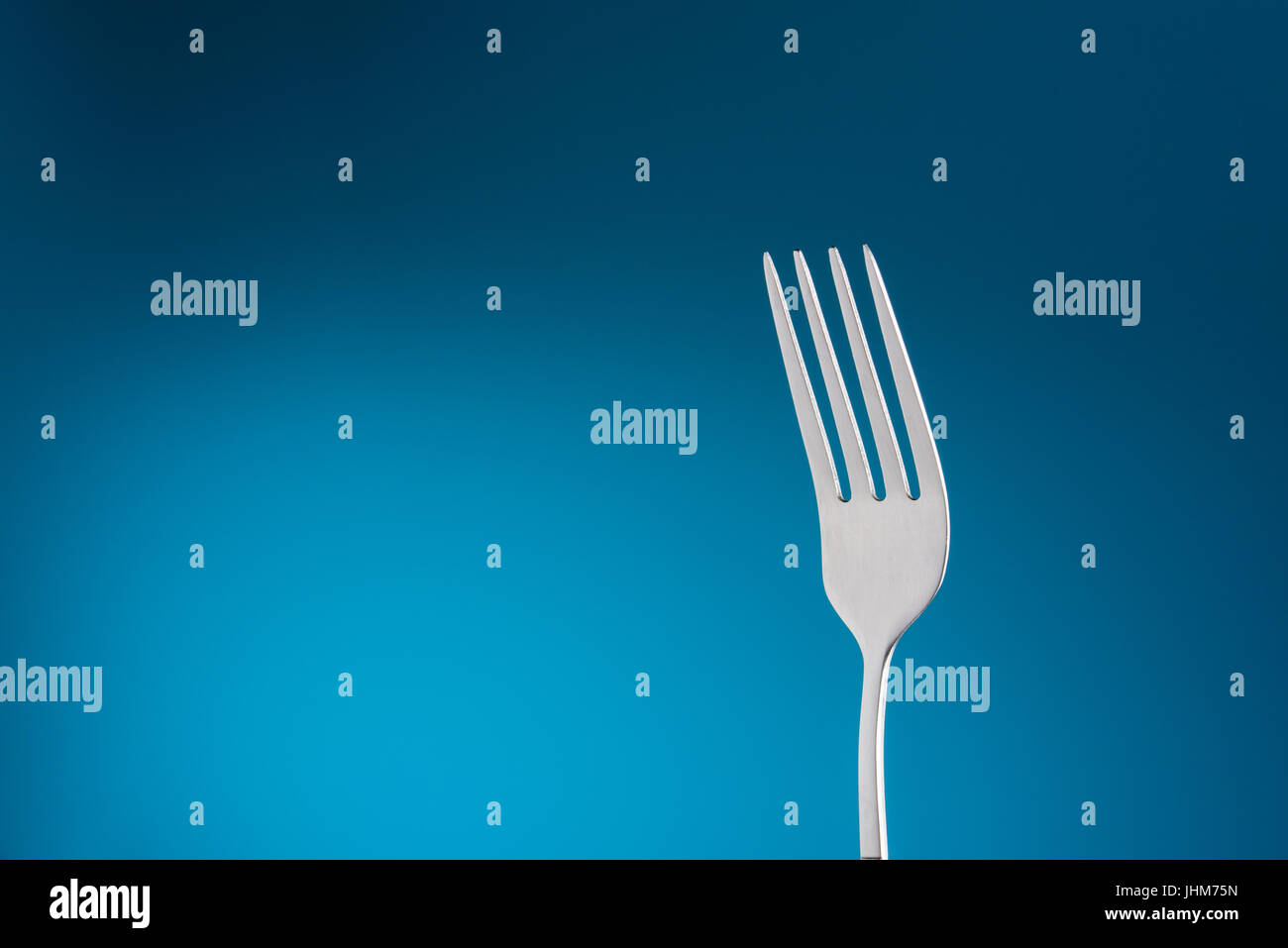 Fork in Blue Background Stock Photo - Alamy