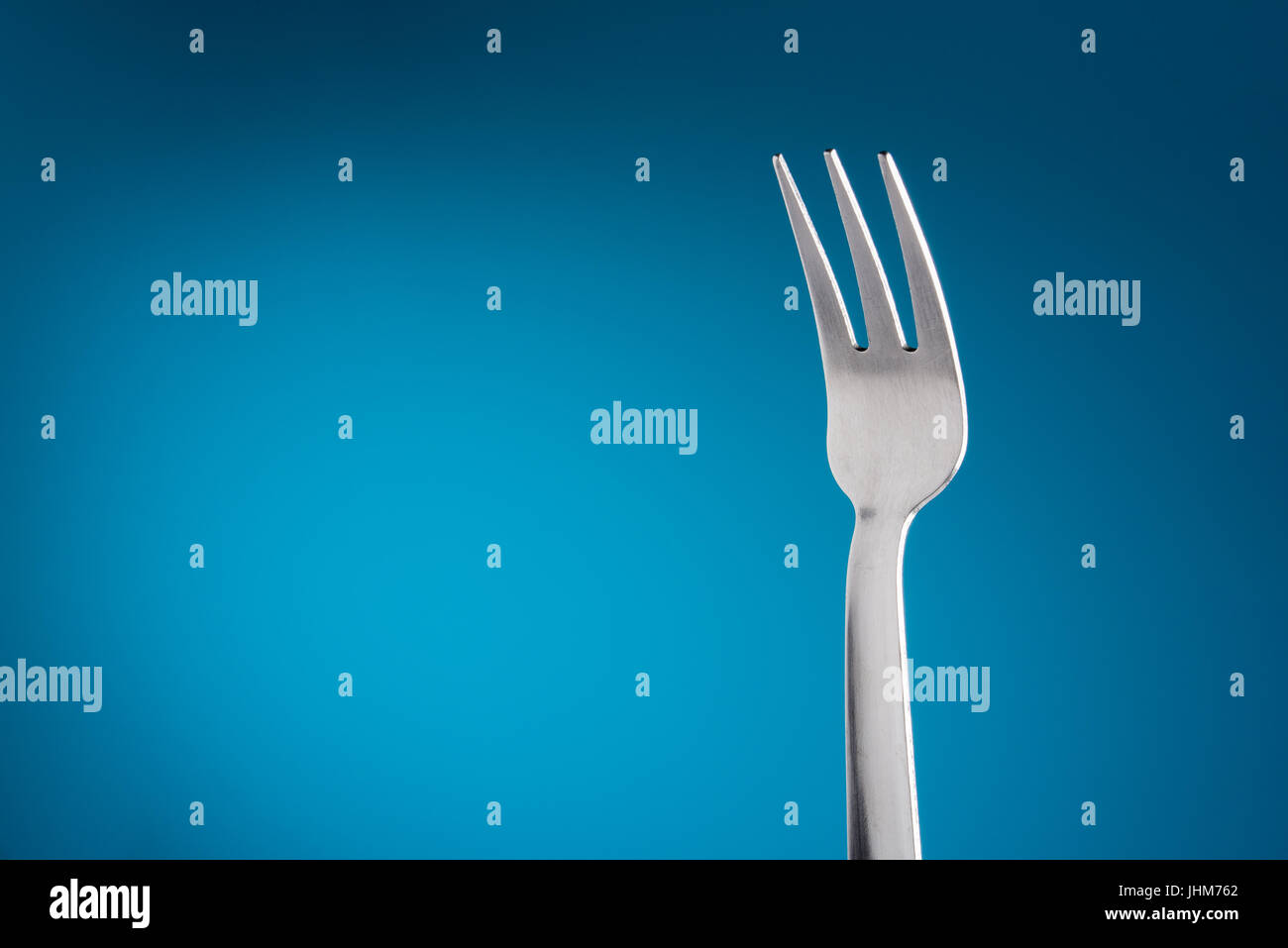 Fork in Blue Background Stock Photo - Alamy