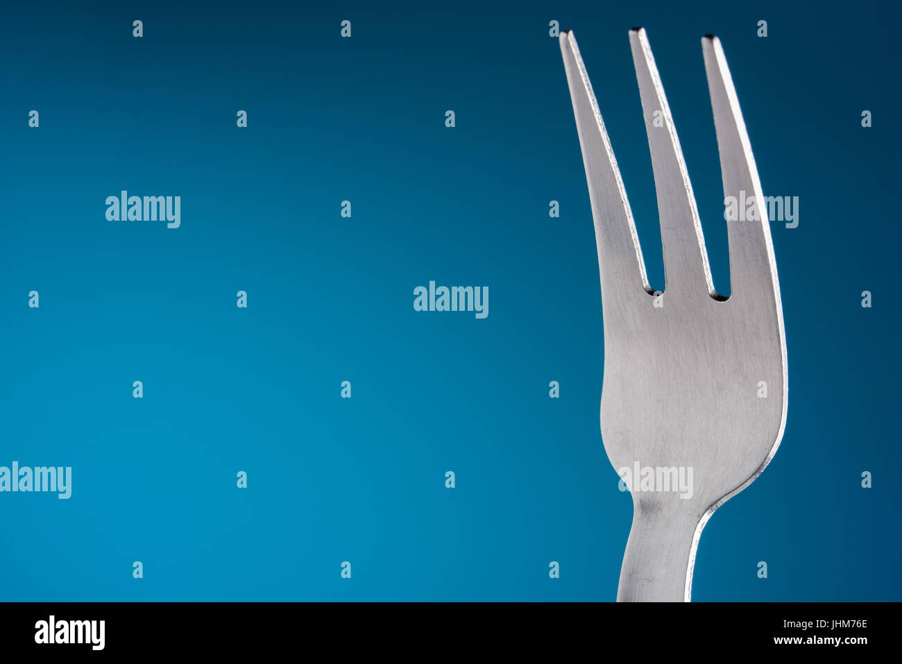 Fork in Blue Background Stock Photo - Alamy