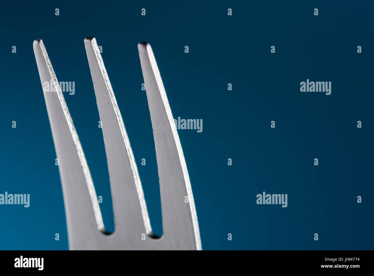 Fork in Blue Background Stock Photo - Alamy