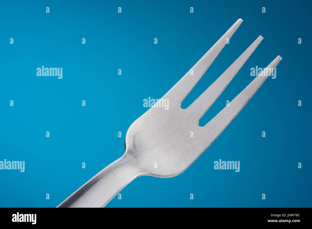 Fork in Blue Background Stock Photo - Alamy