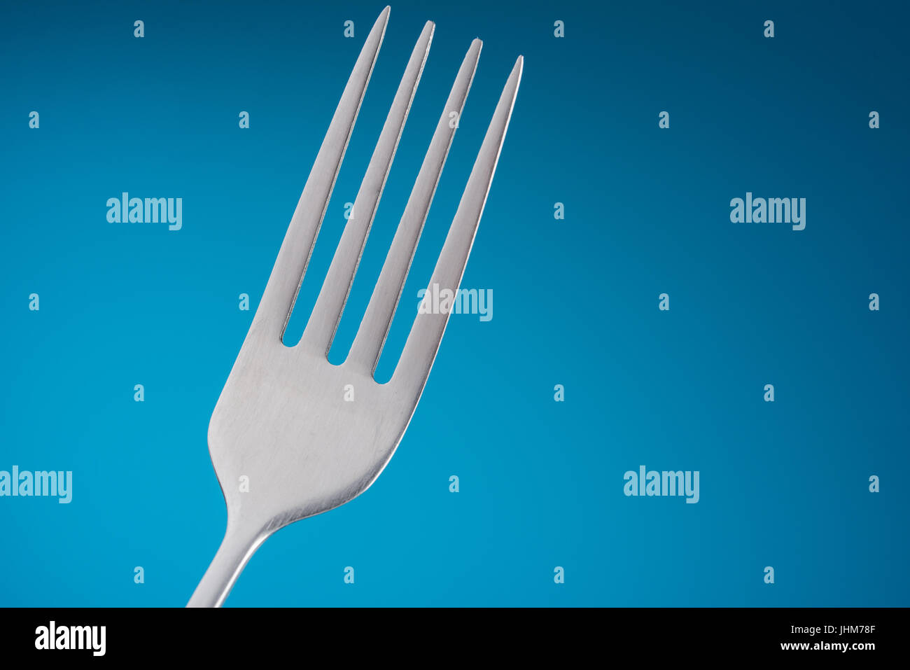 Fork in Blue Background Stock Photo - Alamy