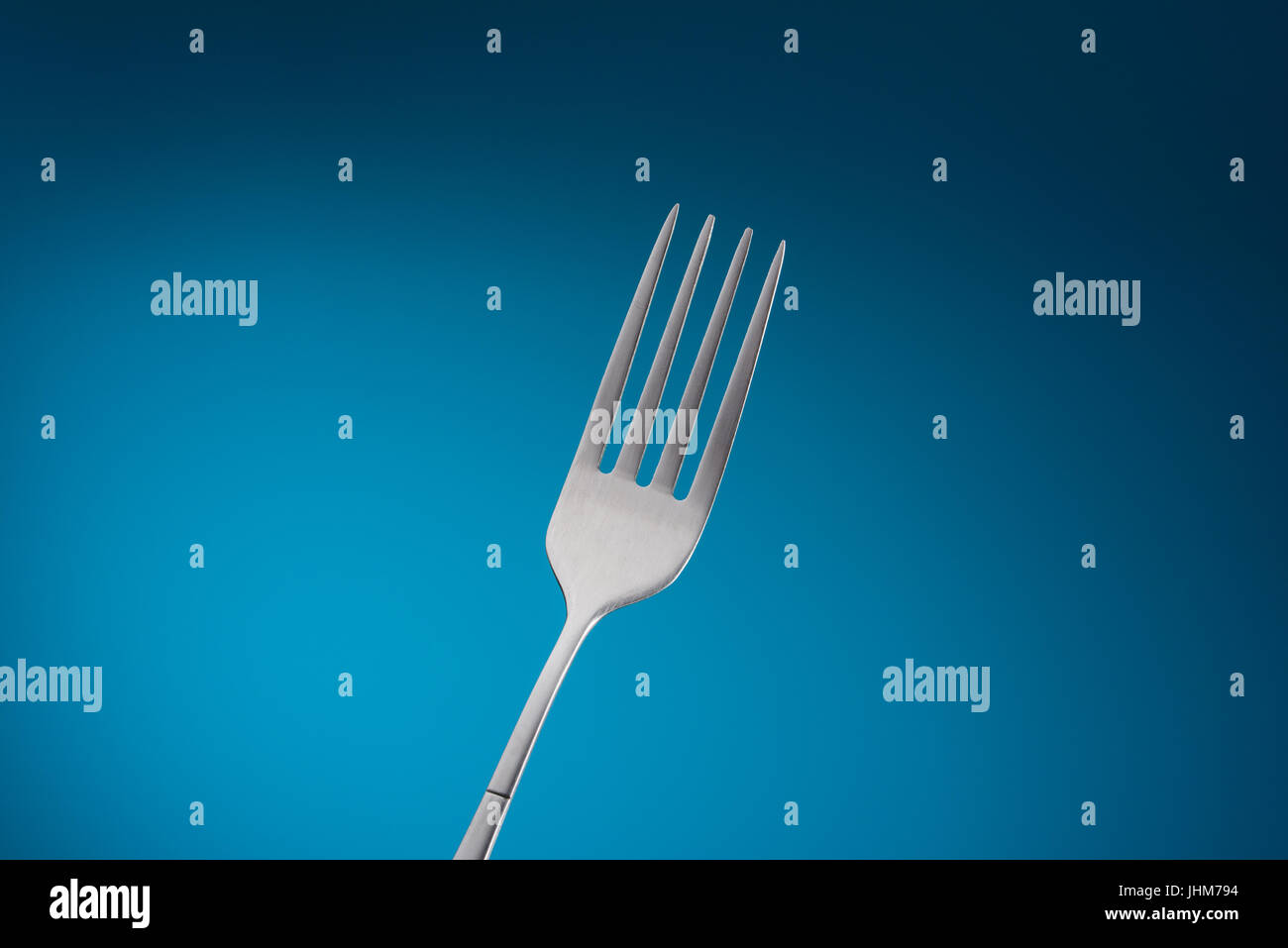 Fork in Blue Background Stock Photo - Alamy