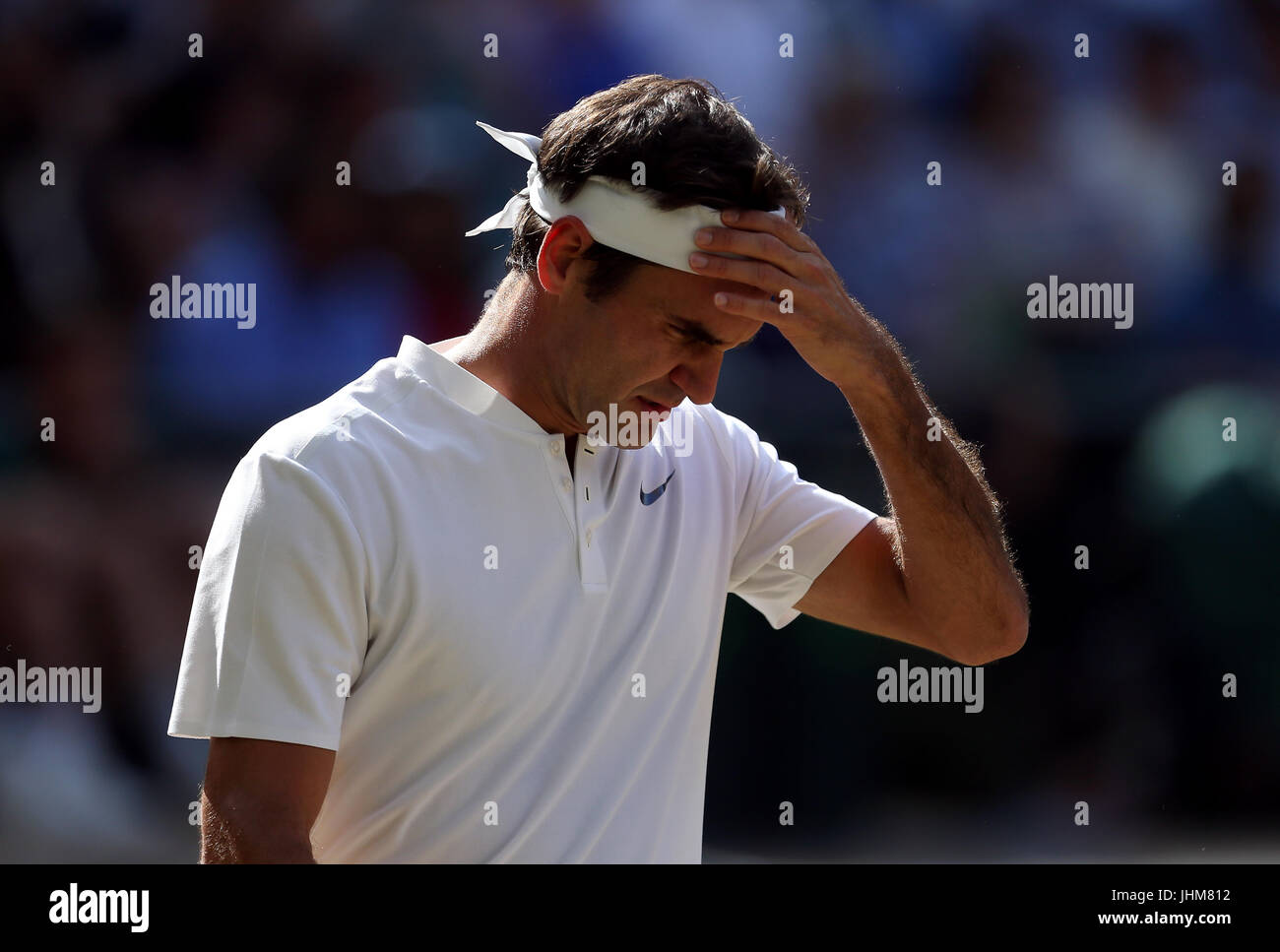 Roger Federer reacts during his match against Tomas Berdych on day ...