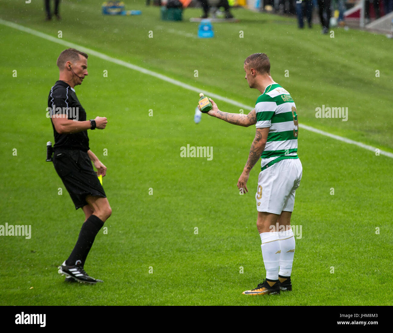 Celtic striker Leigh Griffiths shows the referee an empty bottle of ...