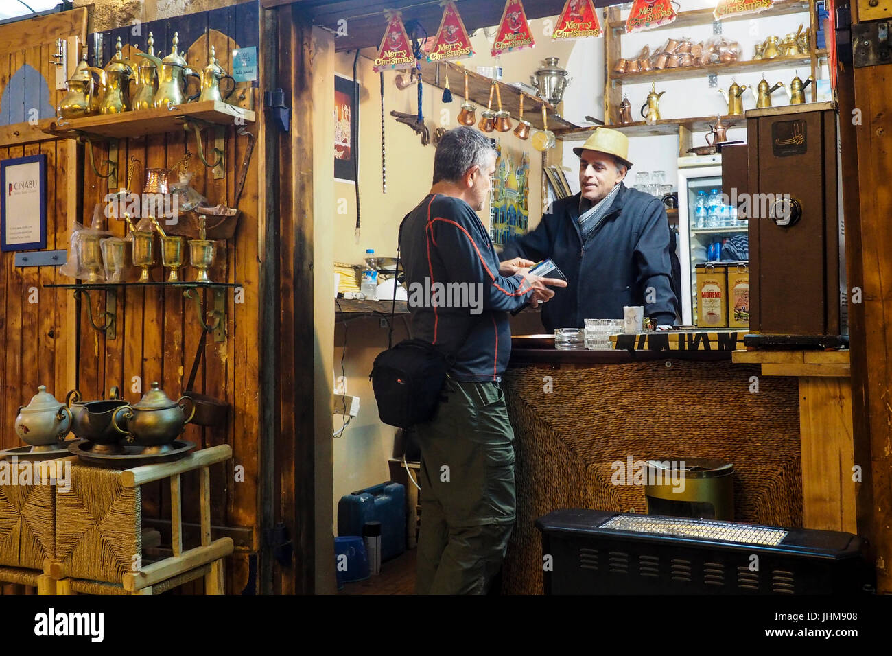 A tourist paying for a coffee in a coffeeshop in Acre, Israel Stock ...