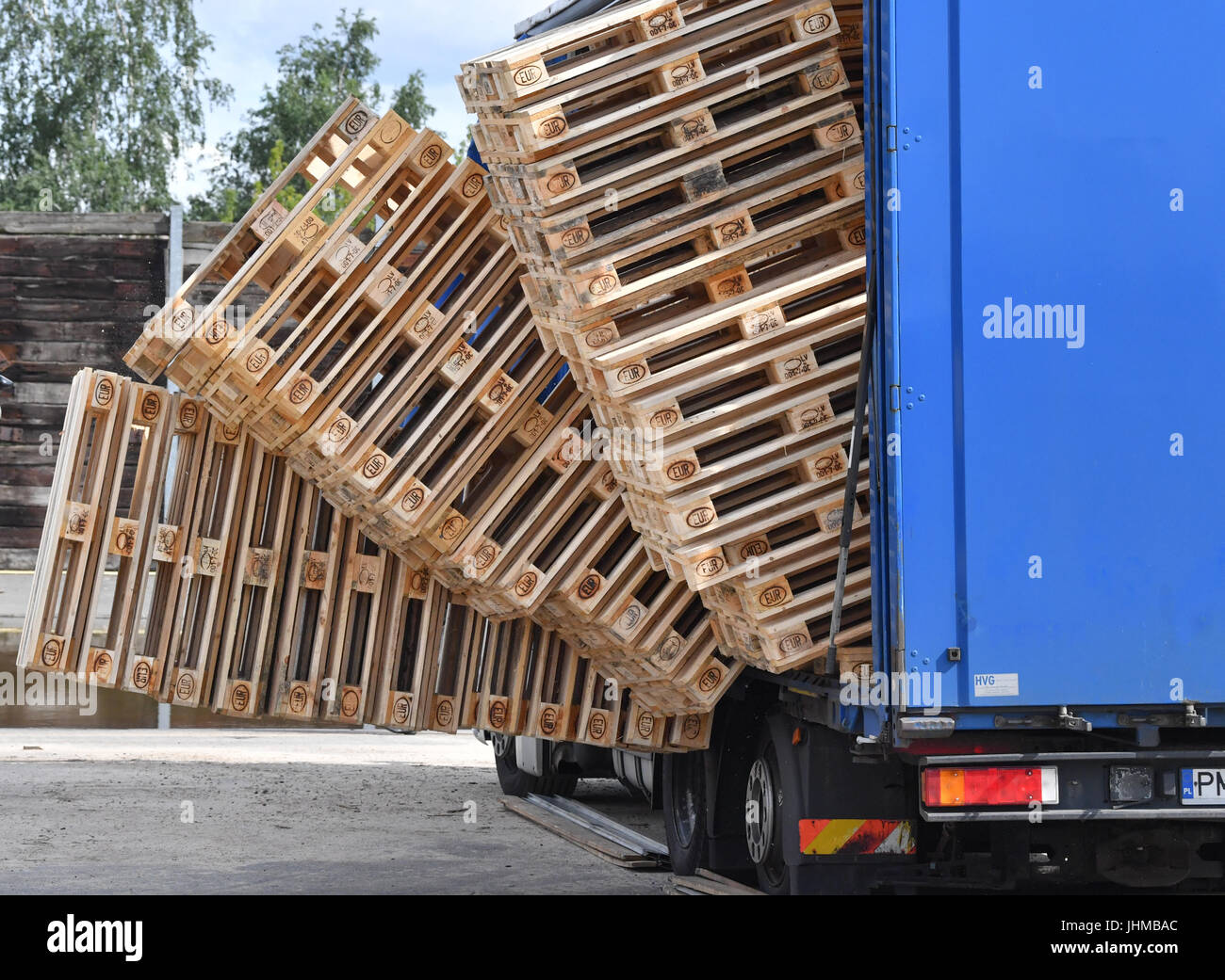 Counterfeit euro-pallets falling out of a truck in the yard of a ...