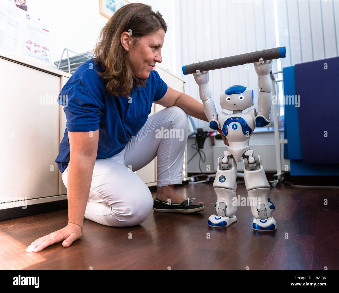 Physiotherapist Stefanie Finn watches the robot Zora in a therapy room ...